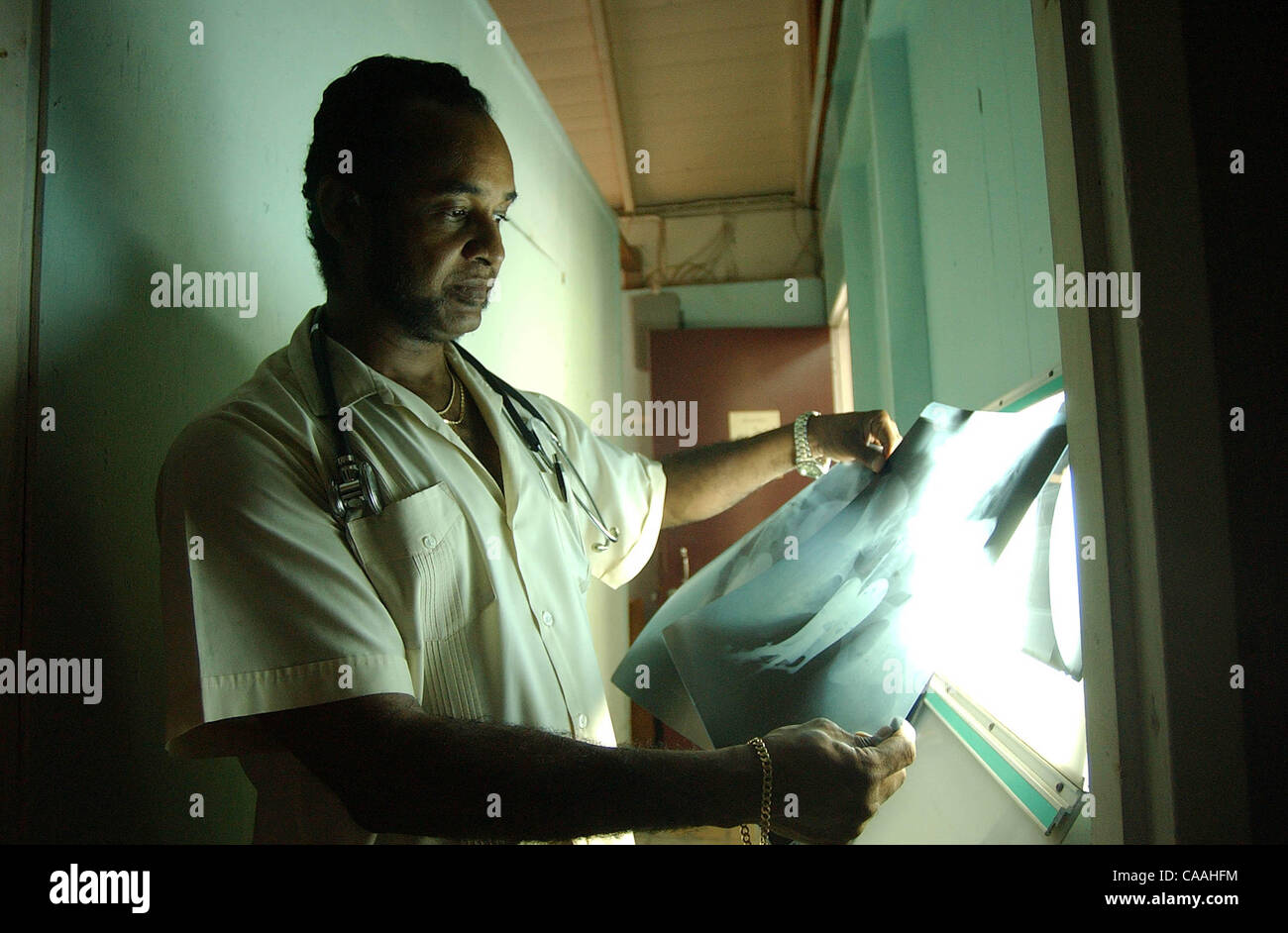 Terrence Marryshow, a Cuban-trained doctor, works in his office in St ...