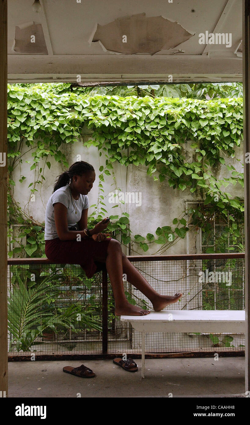 Michelle Charles waits outside the office of Dr. Terrence Marryshow in ...