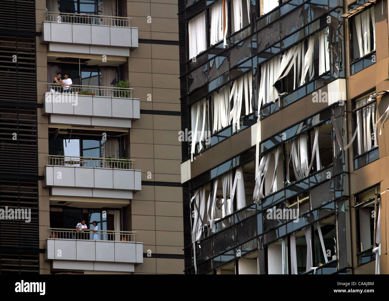 JAKARTA, INDONESIA - AUGUST 6, 2003 Unidentified persons stand on the ...