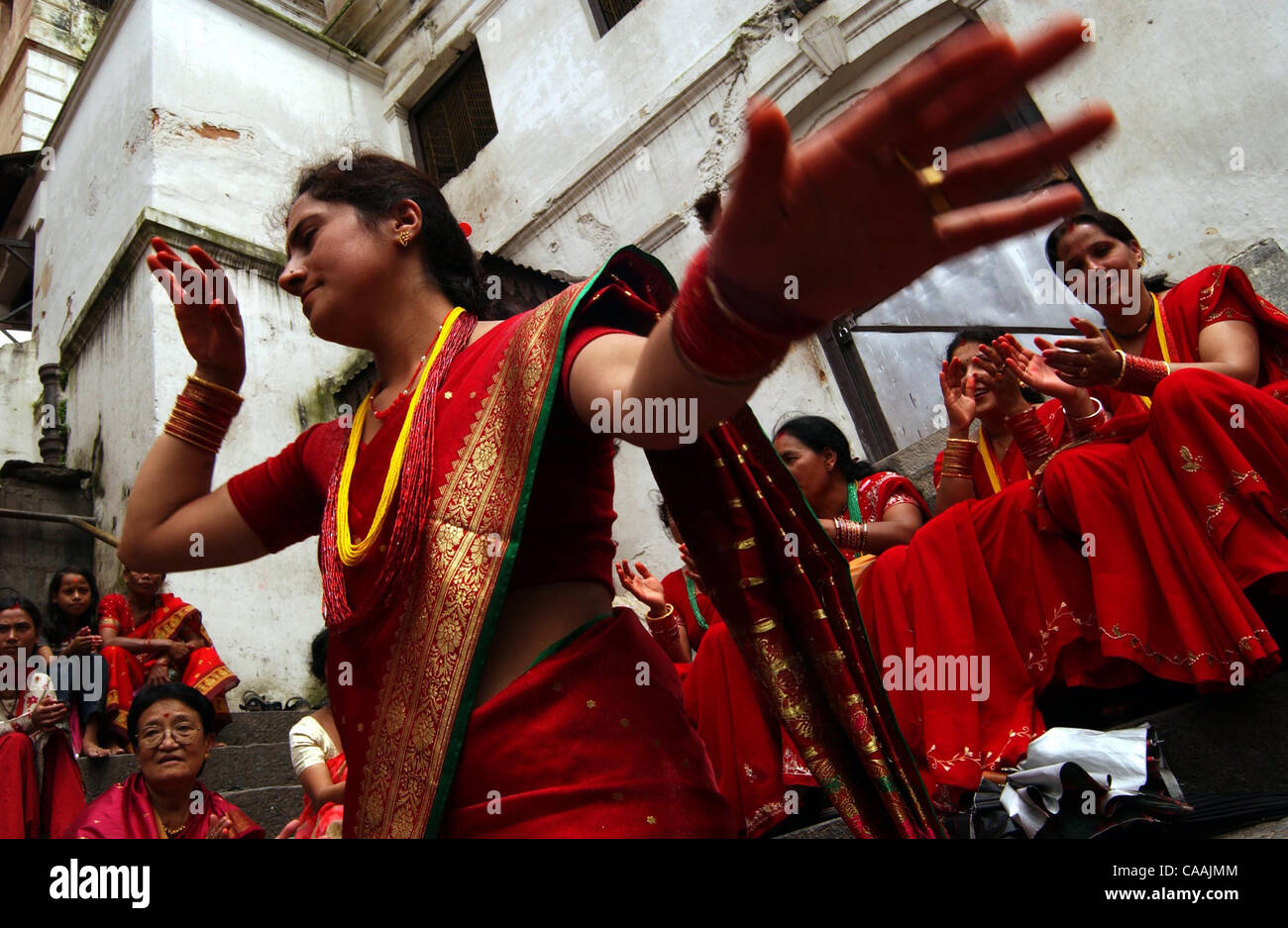 KATHMANDU, NEPAL-AUGUST 30, 2003: A Nepali woman dances atPasupatinath temple to celebrate Teej ...