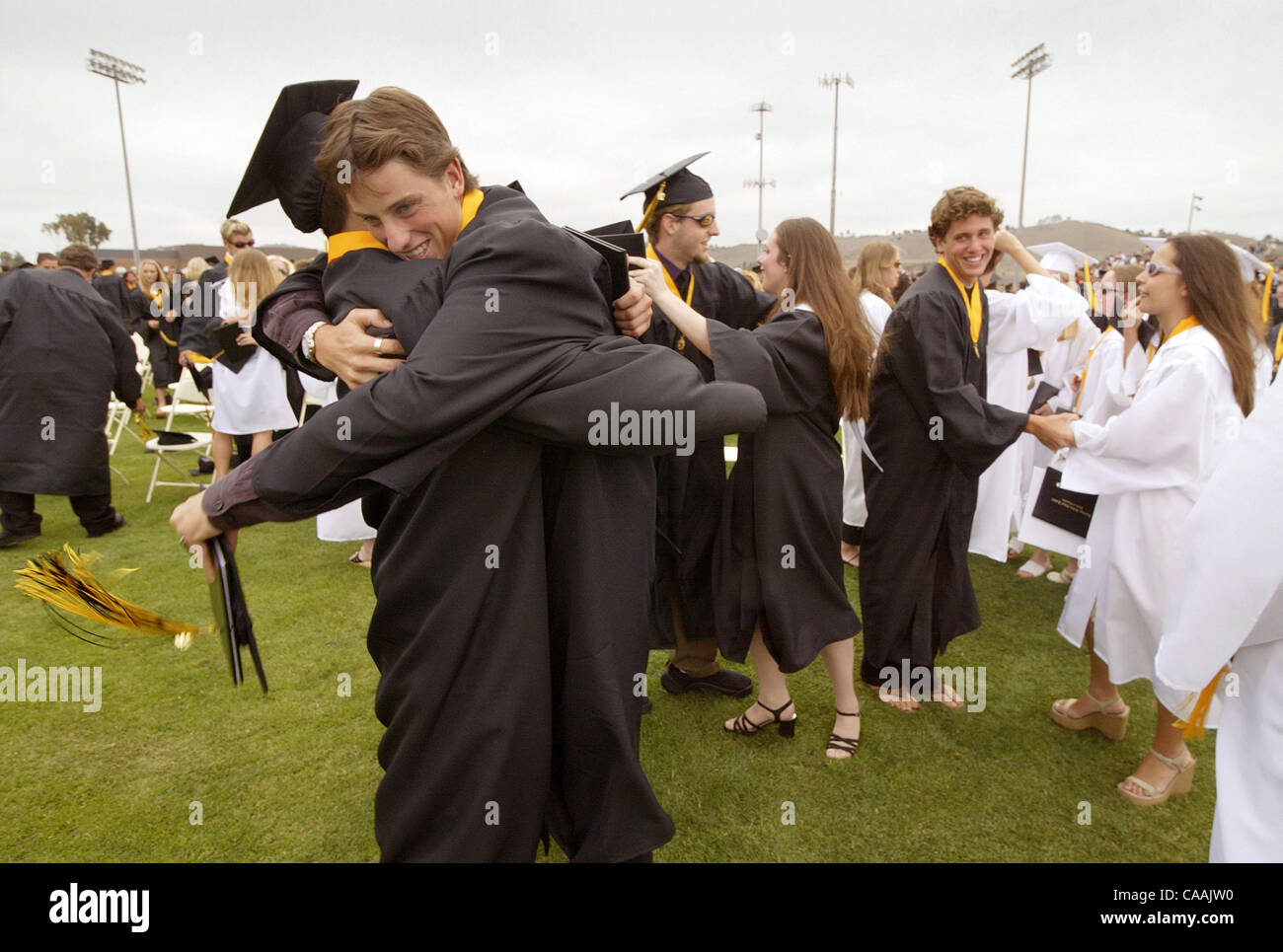 New graduates are congratulated by family, friends, and each other ...