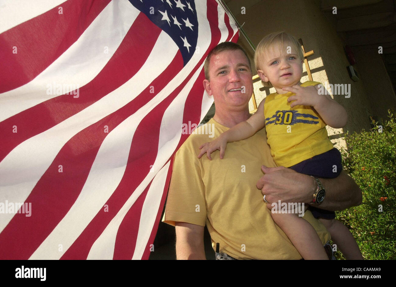 FILE ART: Bob Page holds his 1-year old son Gabriel at his home in ...
