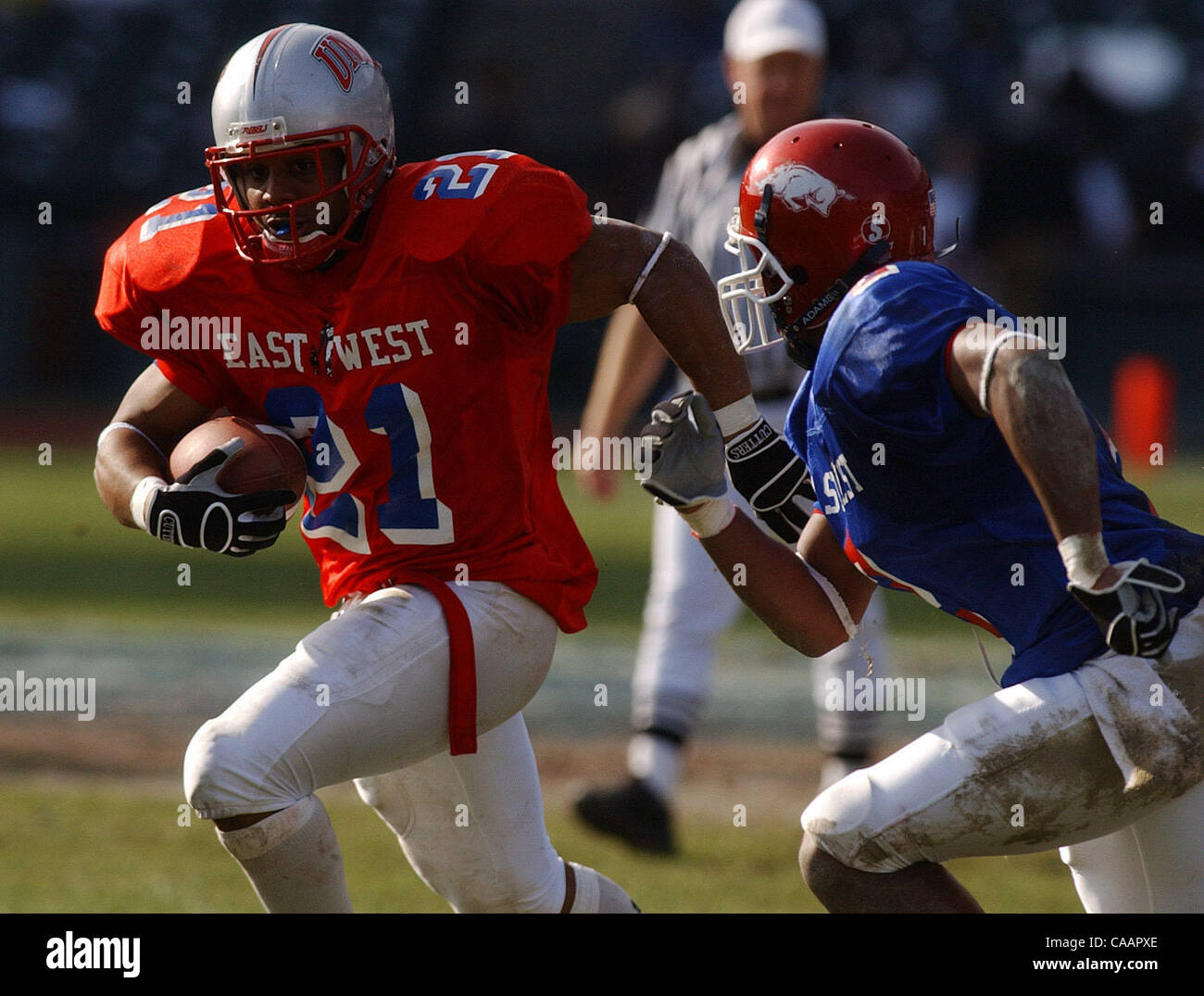 West's Larry Croom, #21, from UNLV, runs past East's Lawrence ...