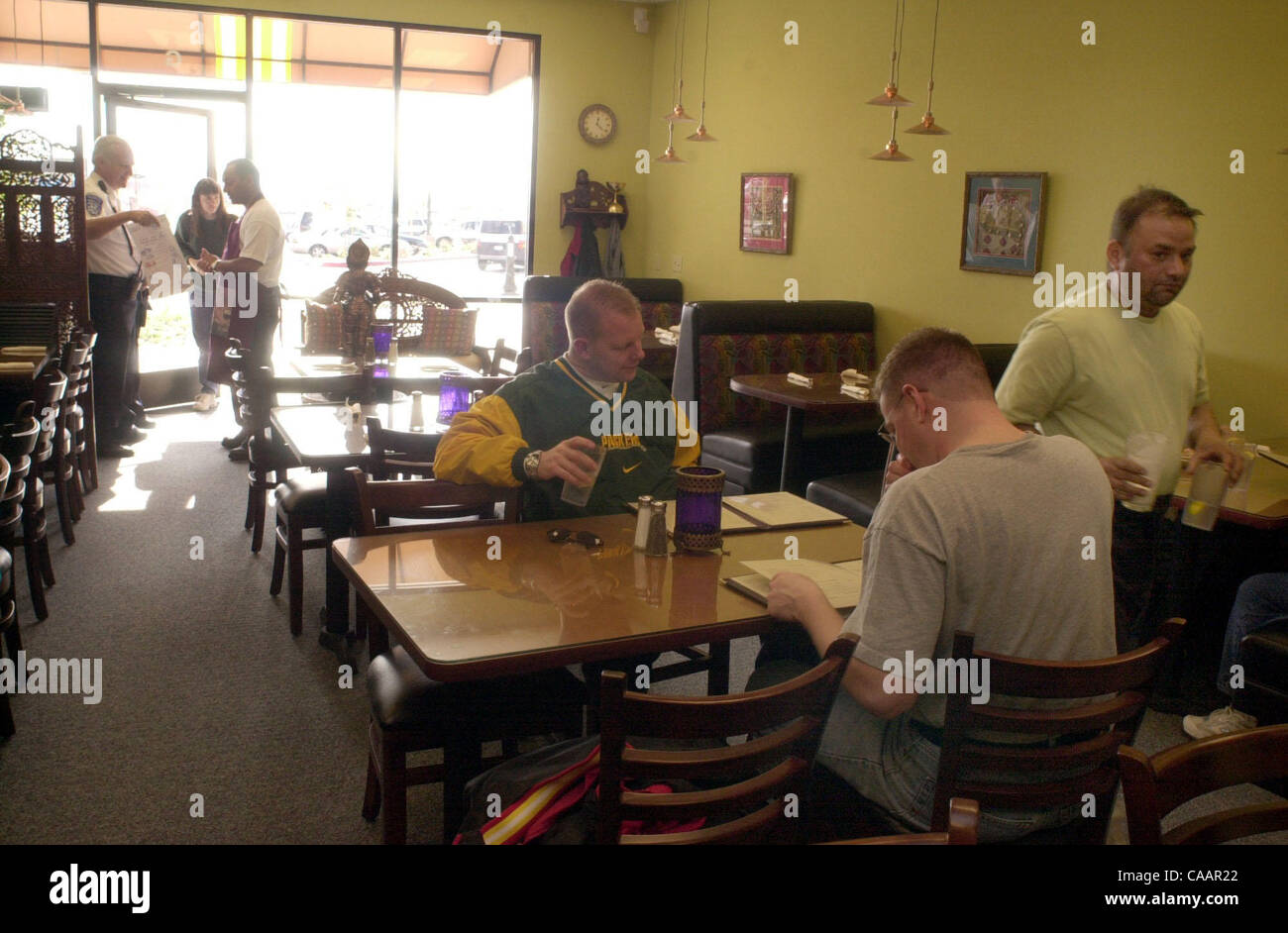 Customers look over the menu at "India 4 "U", a new Indian restaurant ...