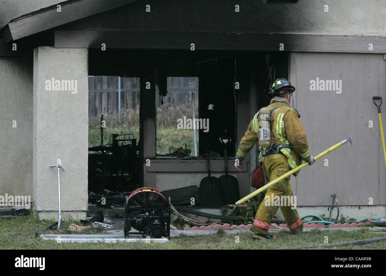 (Published 04/19/2005, B-2) An SDFD firefighter walks by the front of ...