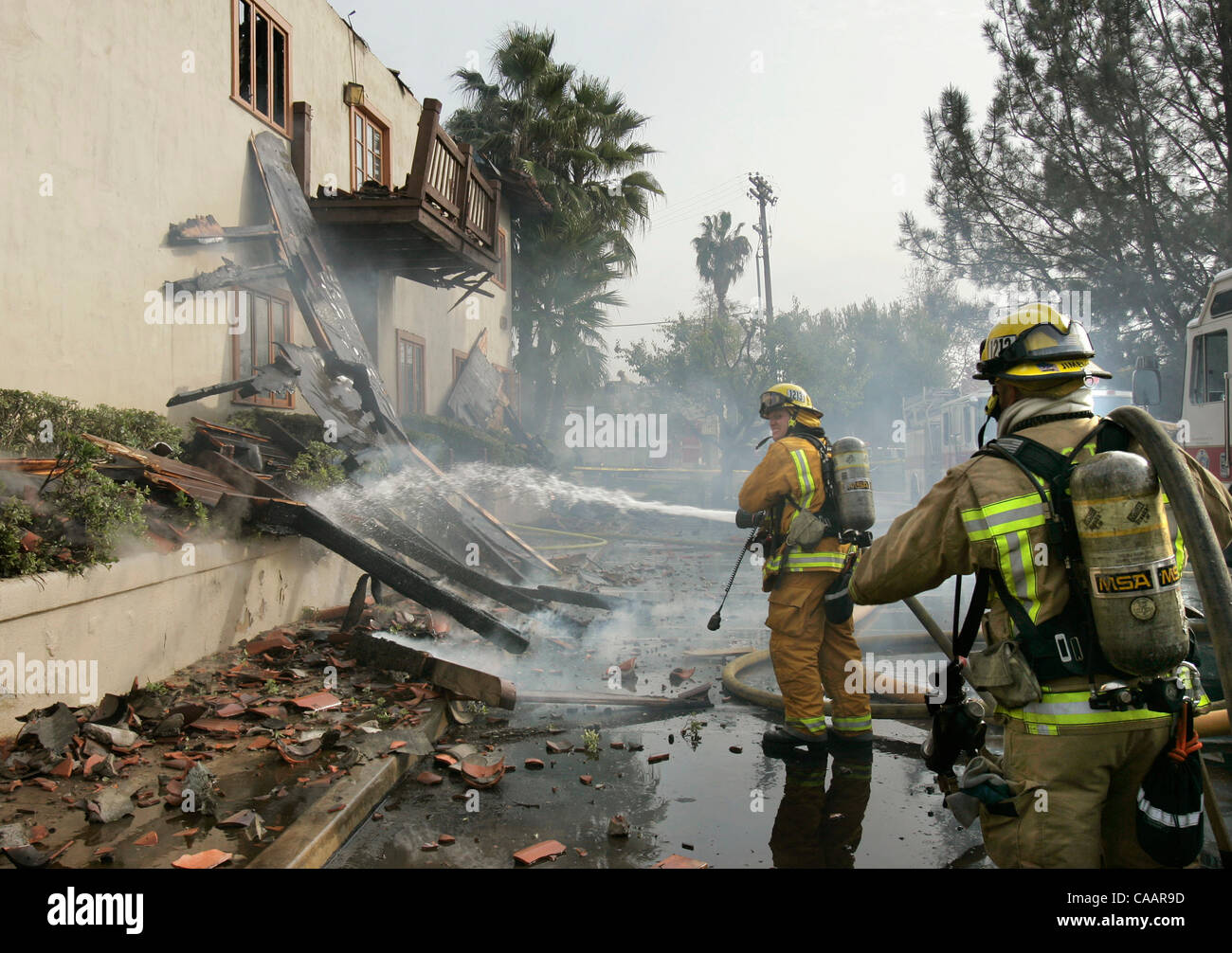 Vista F.D. personnel JAKE SHUMATE (far) and EDDIE JIMENEZ spray water ...