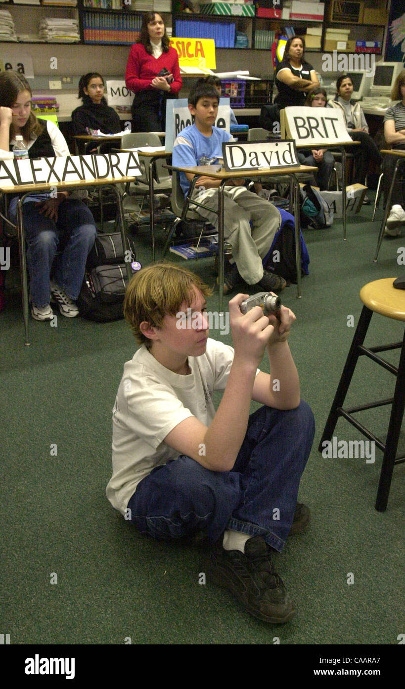Student ANDREW NILES uses a digital camera to take photos of the ...