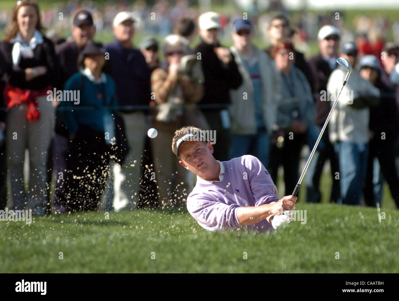 Luke Donald hits out of a sand trap on the 2nd hole of Pebble Beach ...