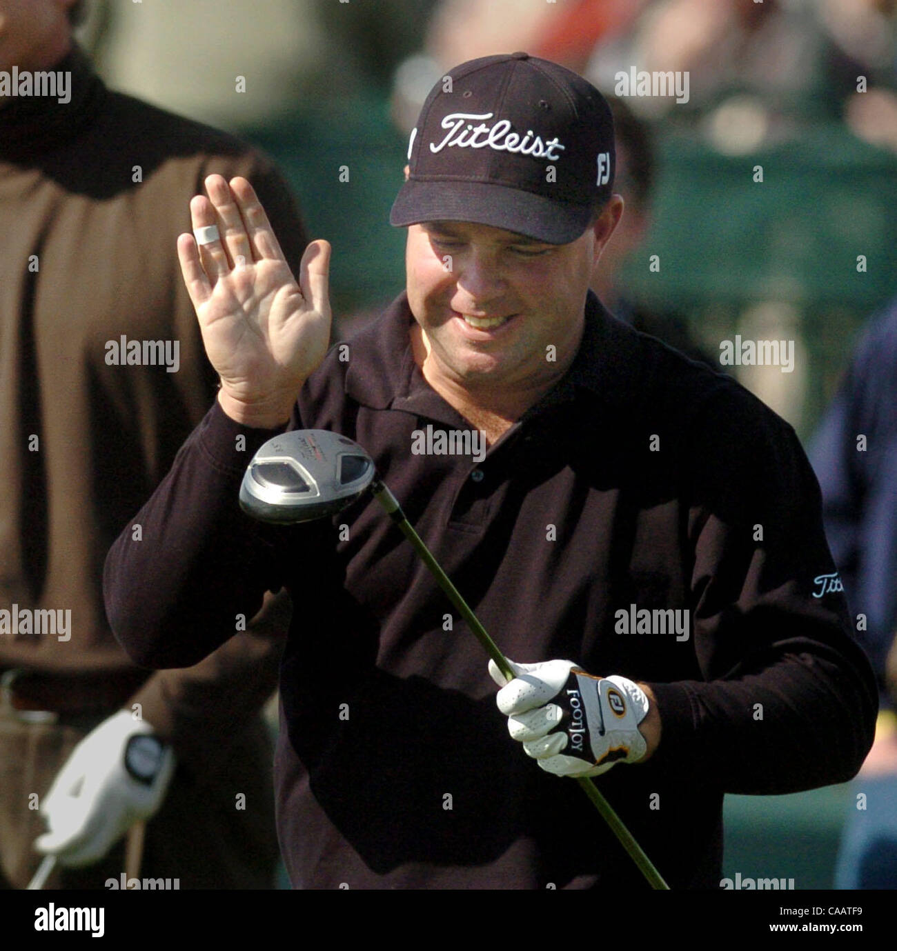 Brian Bateman scolds his driver after hitting an errant drive on the ...
