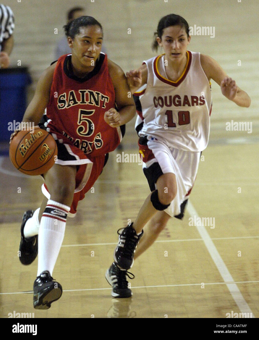 St Mary's High's #5 Natty Fripp drives down court as Carondelet's #10 ...