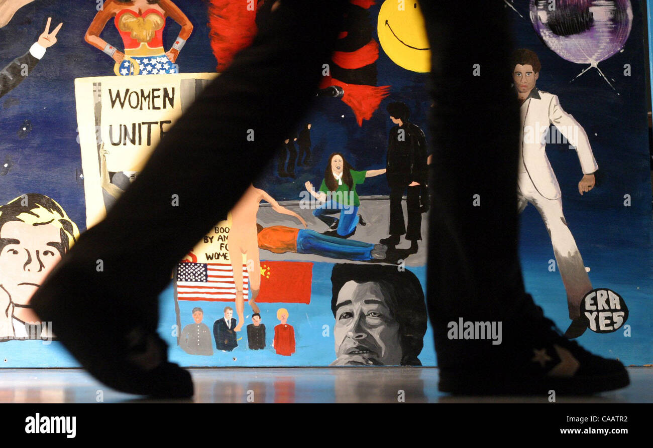 A visitor walks by a mural depicting the 1970's during the school's ...