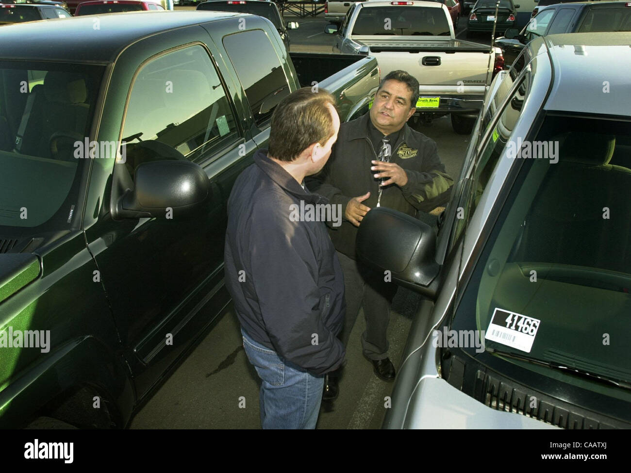 Groth Bros. Chevrolet's Bob Alarcon (top) talks to customer John Rosas ...