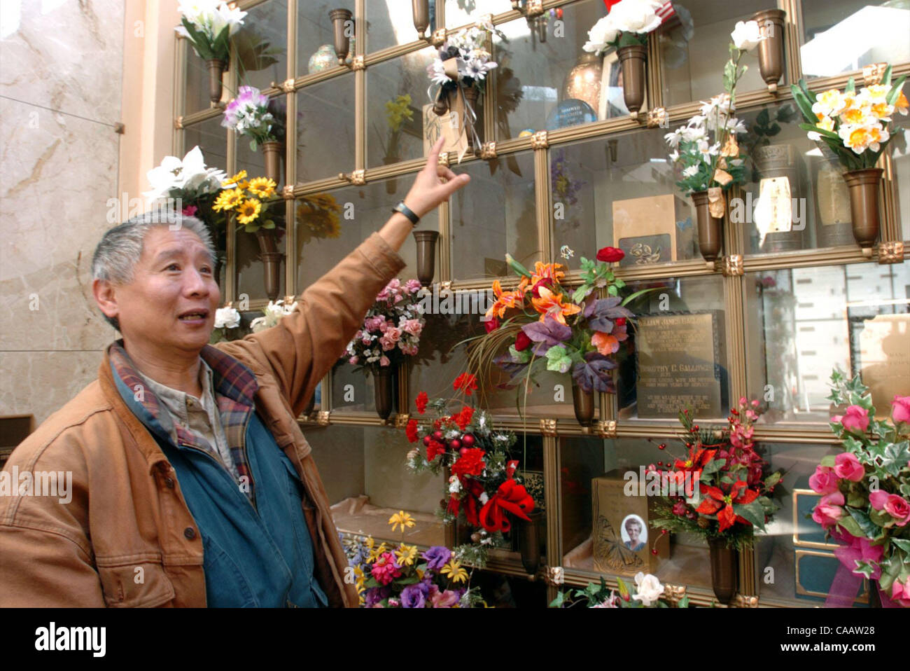 Wah Sin, father of Alice Sin, points to her resting place as he speaks ...