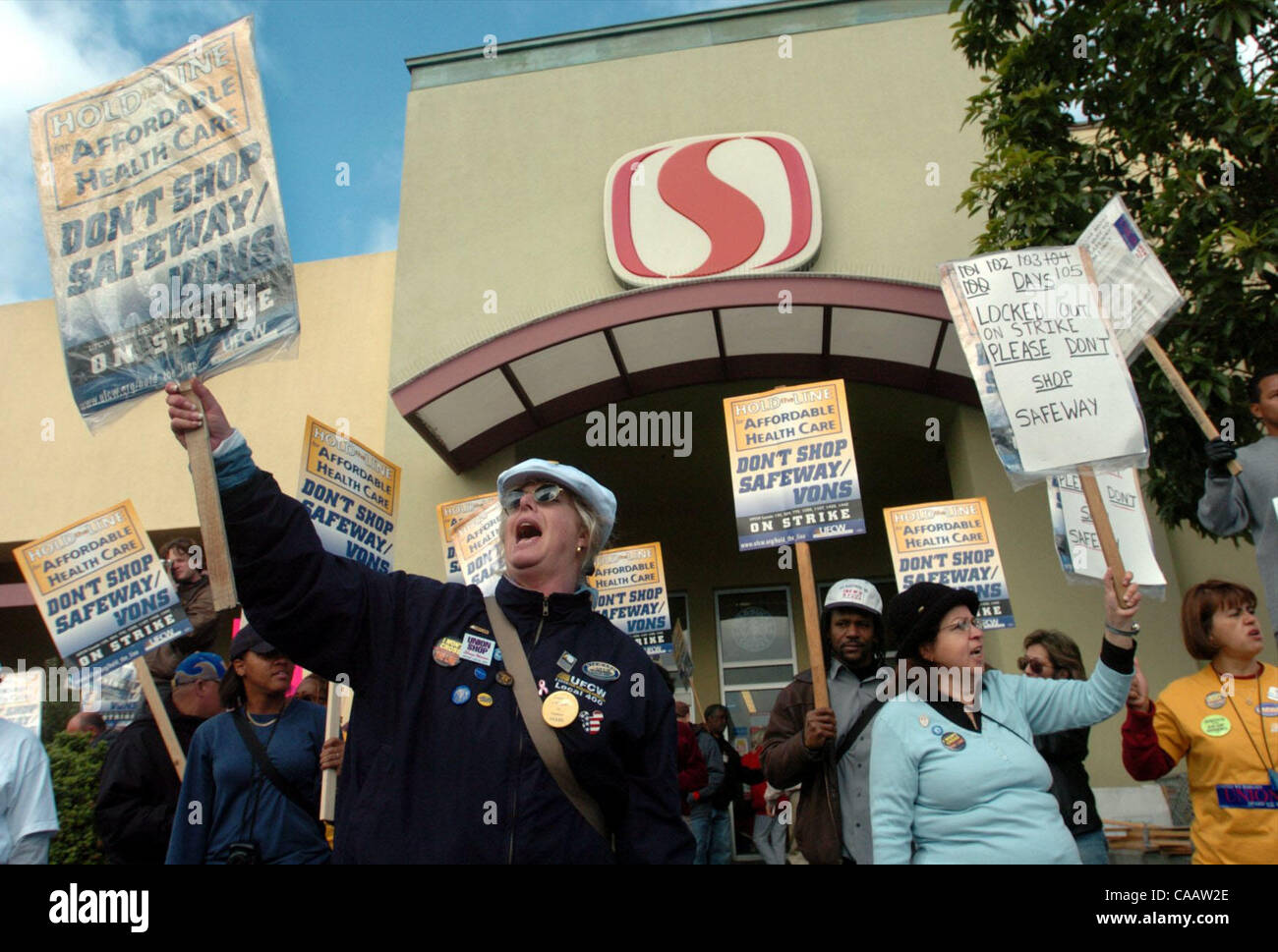 E.J. Patricia Palmer, a Vons employee, (left) chants with other union ...