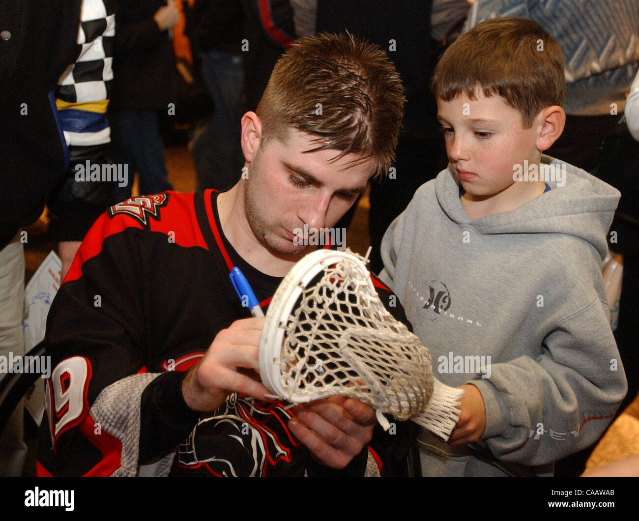 San Jose Stealth's Josh Sanderson, #19, autographs the stick of Wyatt ...