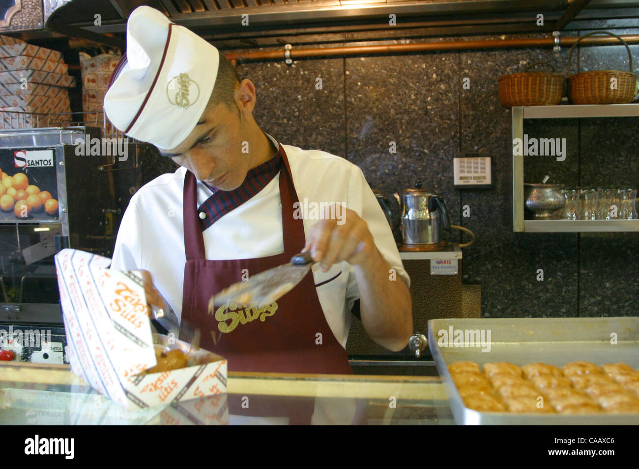 Packing sweets (Baklava) in a sweet shop on Istiklal Caddesi, the large ...