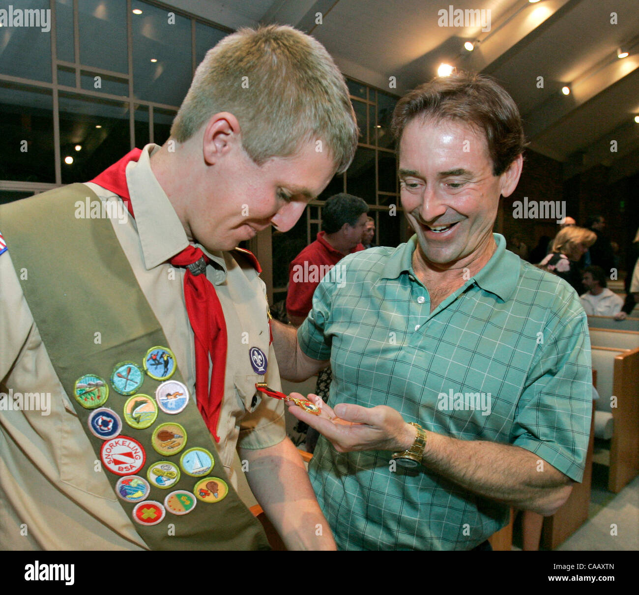 JOHN SILVERWOOD, at right, admires his son BEN's Boy Scout Honor Medal ...