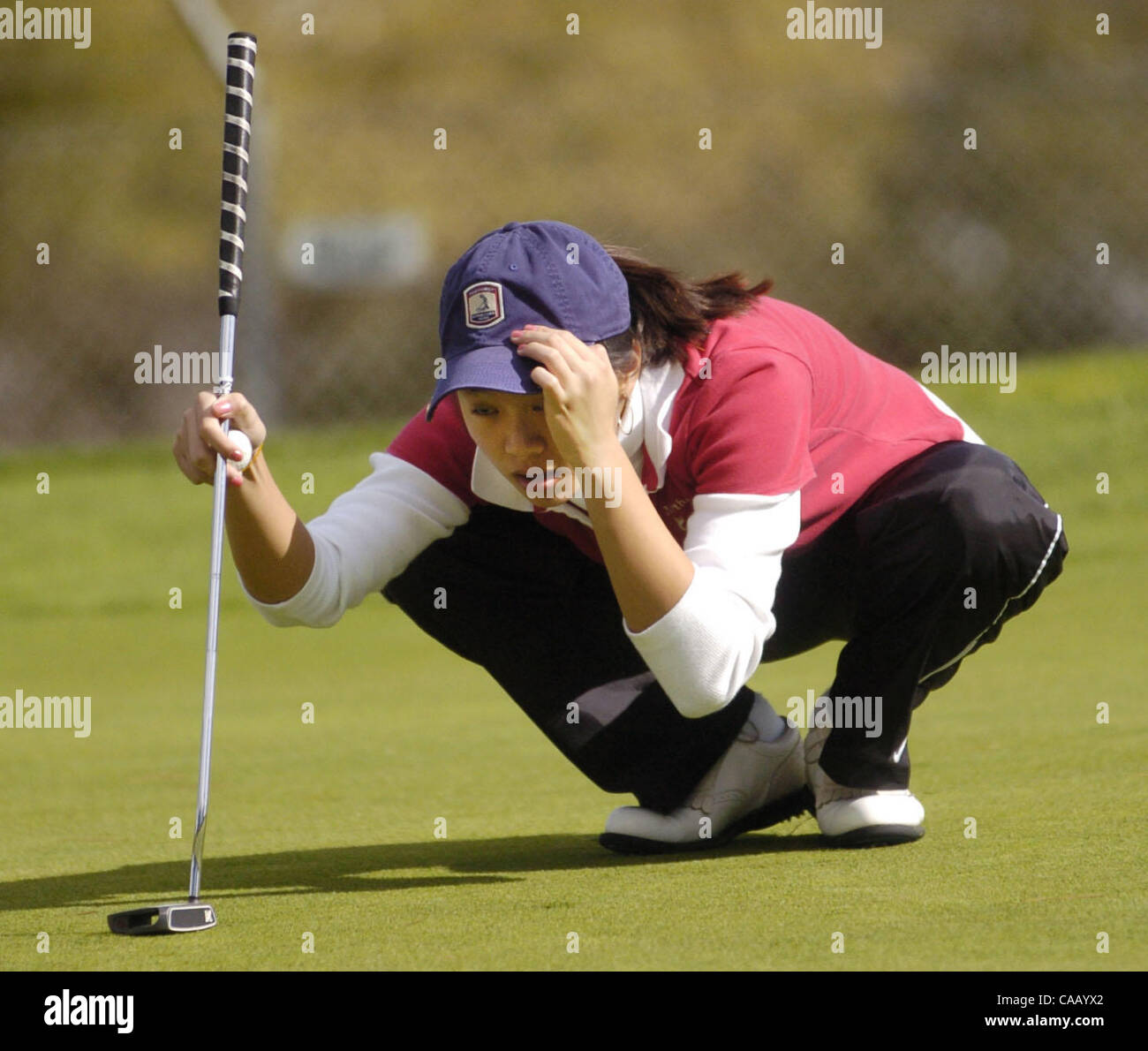 Linda Ong of Northgate High School Women's golf team, looks over a putt ...