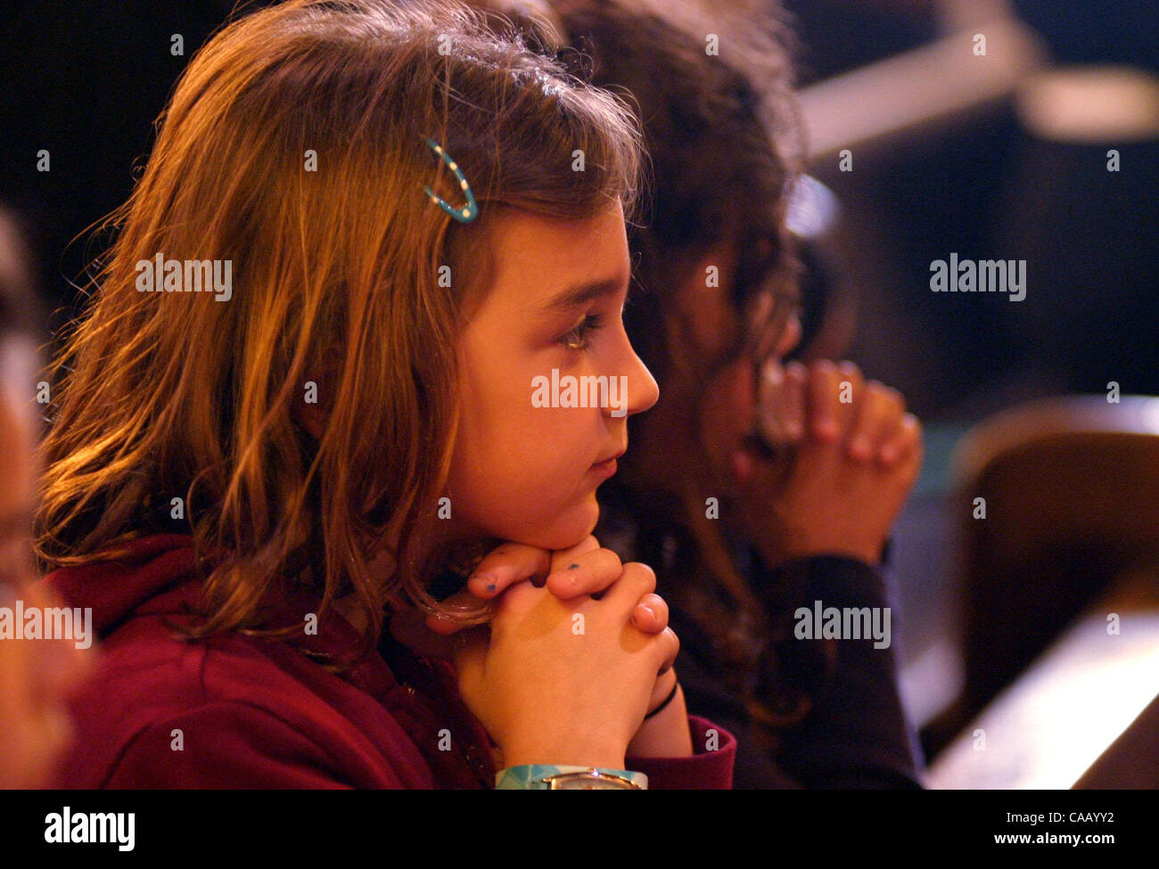 Katelyn Digiorgio (left) and Alexandra Escobar pray during an Ash ...