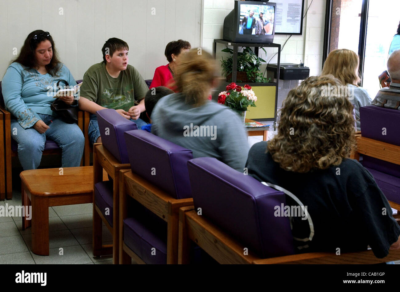 HUGO, OKLAHOMA Texas resident Sarah Allred (reading book) and her son ...