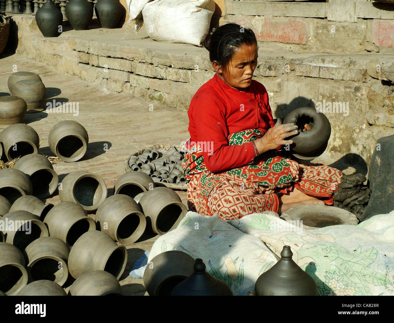 Apr 01, 2004; Bhaktapur, NEPAL; While potters knead clumps of clay or ...