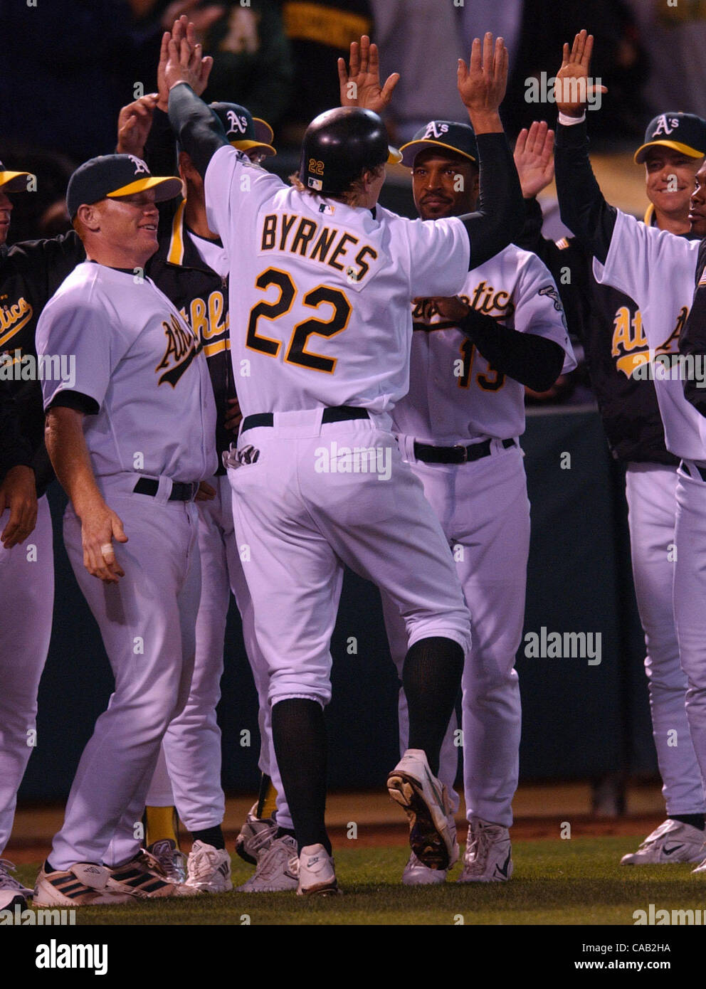 Oakland Athletics Eric Byrnes, #22, celebrates with his teammates after ...