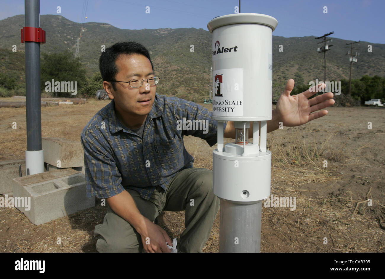 SDSU field station scientist JOHN KIM checks the function of a fire ...