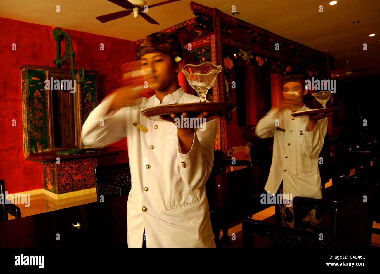 MALANG, EAST JAVA, INDONESIA A waiter walks to serve guest at dining ...
