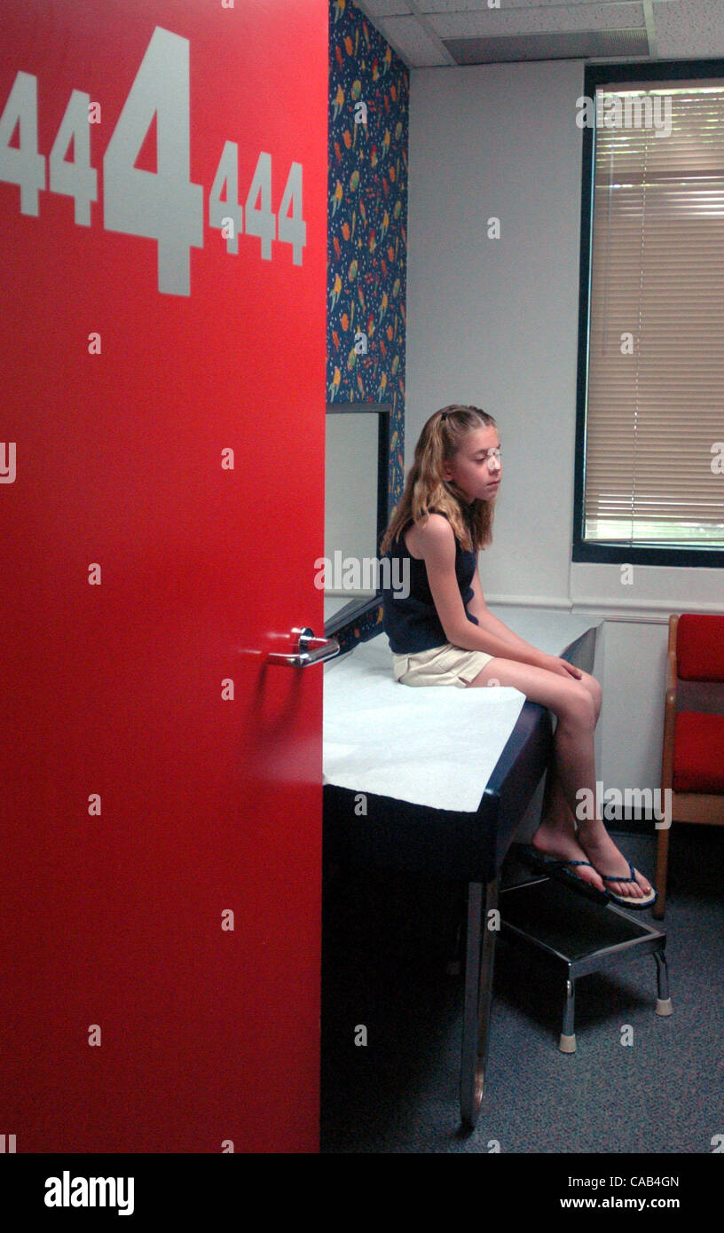 Courtney Gosney, 8, waits to be examined for headaches and stomach pain ...