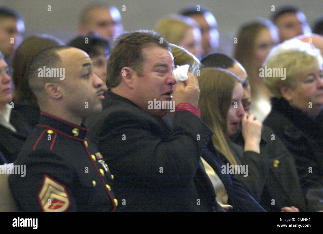 Mark Crowley, 2nd from left, wipes tears from his eyes during a funeral ...