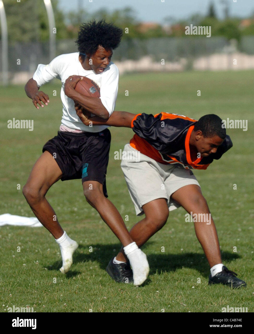 Taiwan Jones (cq)(left) tries to escape the grasp of Tino Smith (cq ...