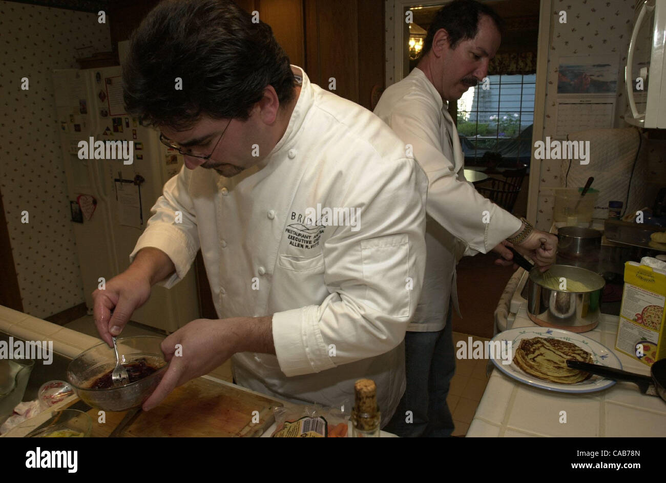 Chef Allen Vitti, of Bridges Restaurant, left, finishes the blood ...