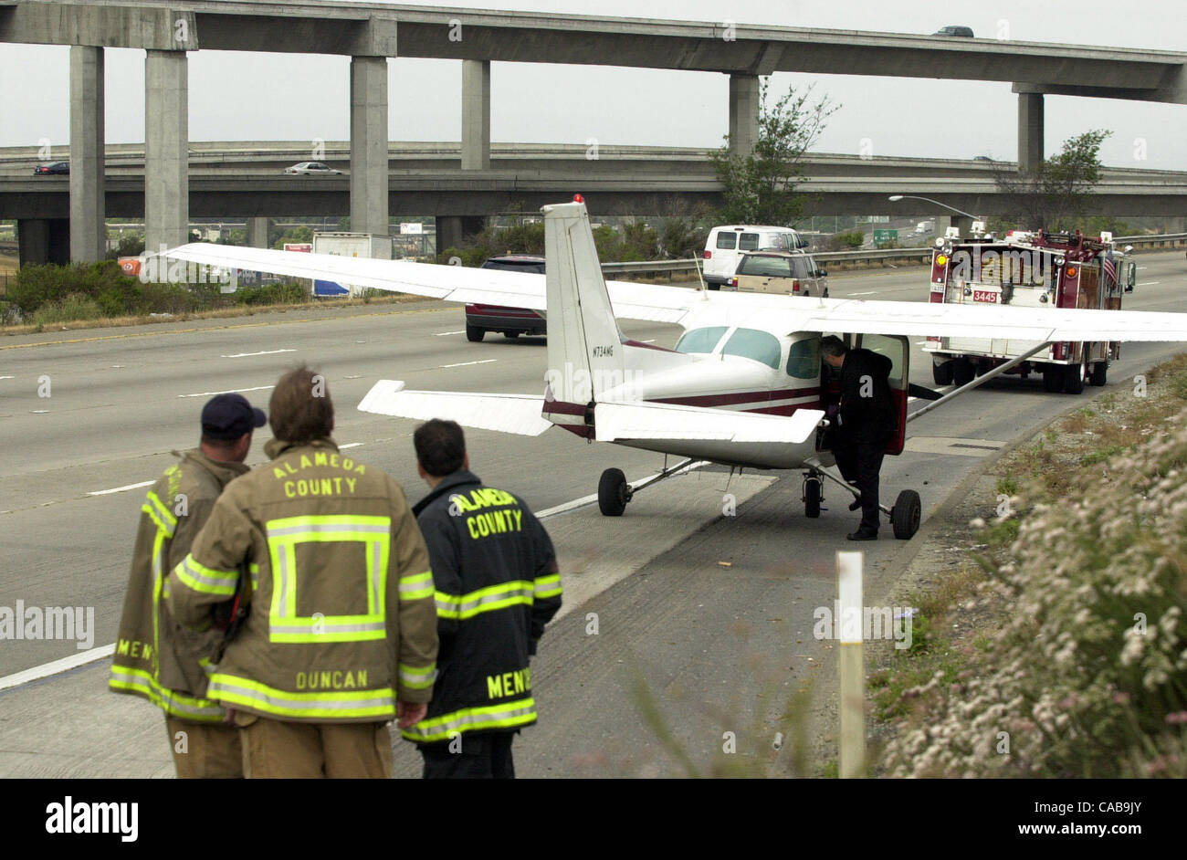 Alameda fire department personnel watch as FAA investigator Denny ...