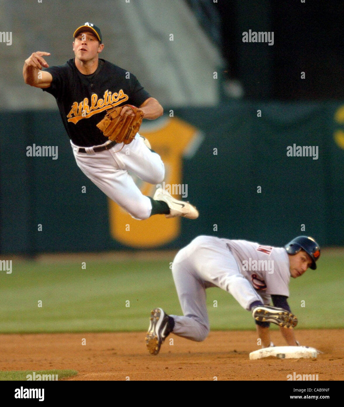 A's shortstop Bobby Crosby gets airborne while turning a double play as ...