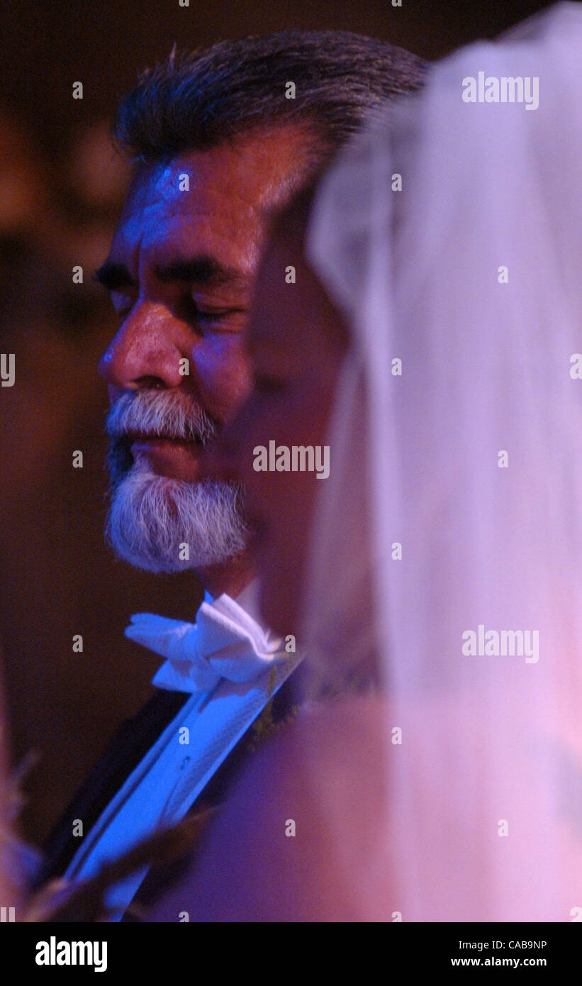 Frank J. Ballesteros (cq)(left) closes his eyes for a brief moment ...