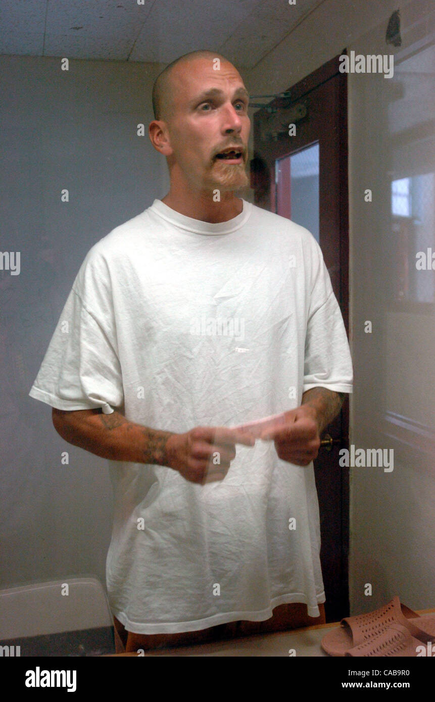 Steven Payne talks from behind glass in a visiting room during an ...