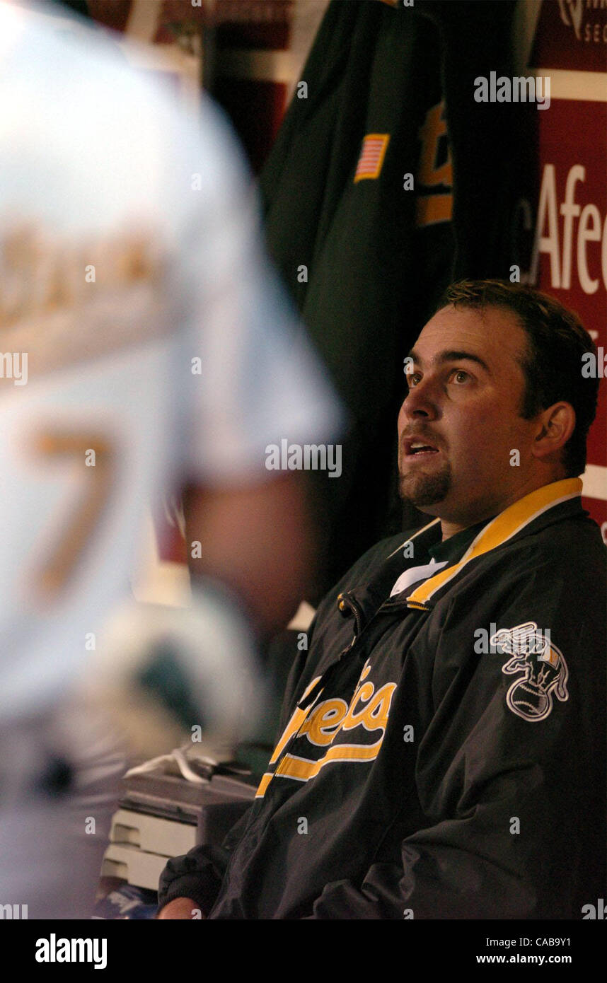 Catcher Damian Miller and pitcher Mark Redman of the Athletics talk in ...