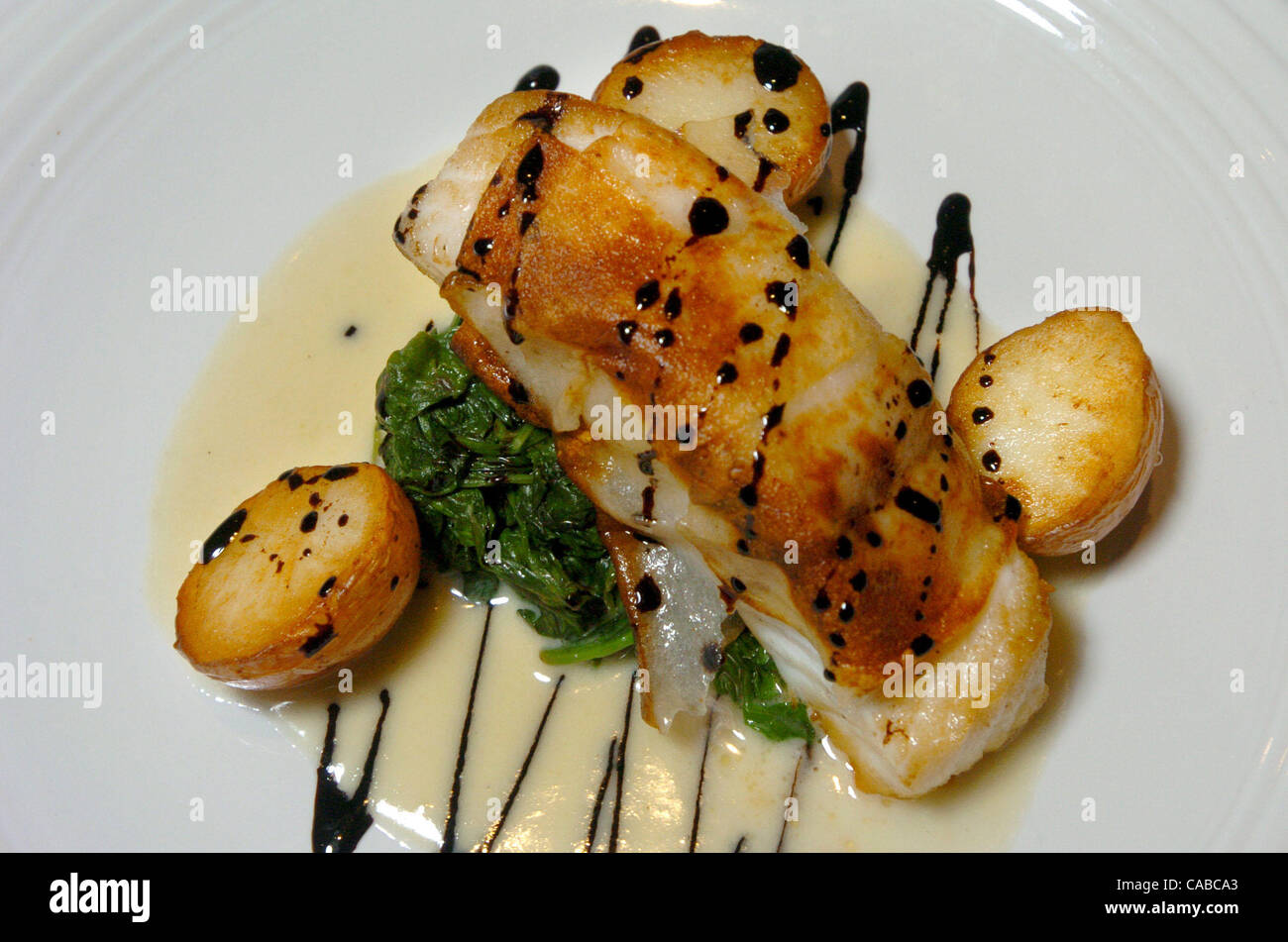 This plate of potato-wrapped halibut drizzled with balsamic syrup, by ...
