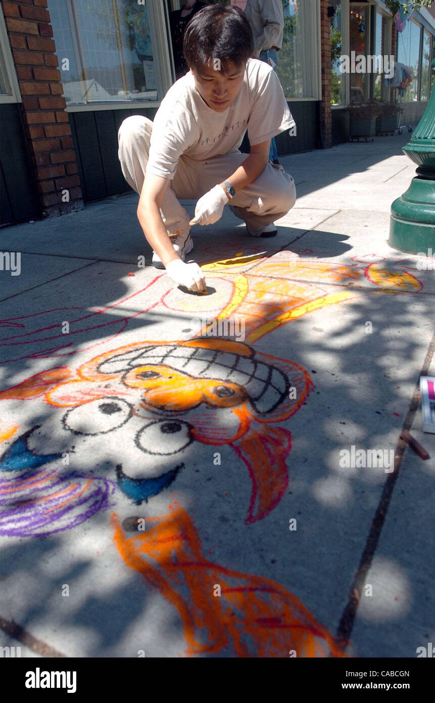 Frank Cai works on his chalk art dragon drawing during the annual ...