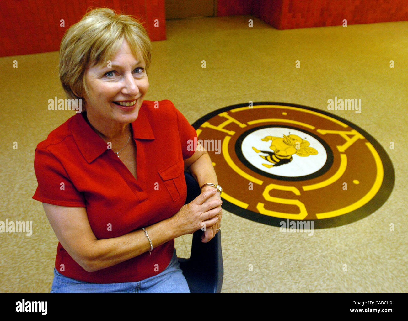Principal Margie Sheratt sits by the Alameda High school seal that was ...