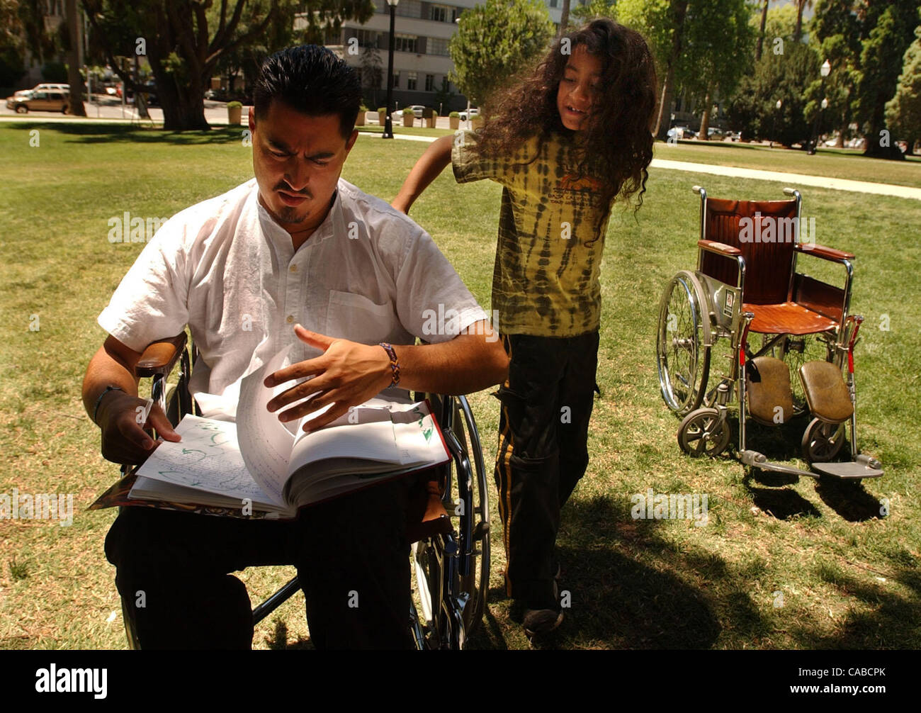 César A. Cruz, age 30, from Berkeley, flips through his journal as ...