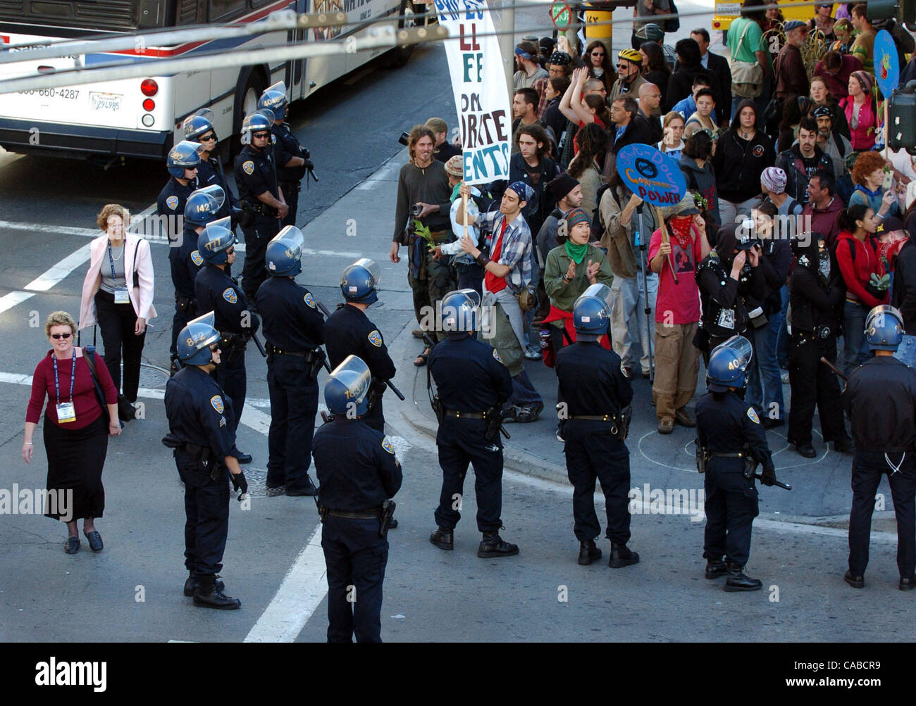 A Biotech convention-goer walks past a gauntlet of riot-clad police ...