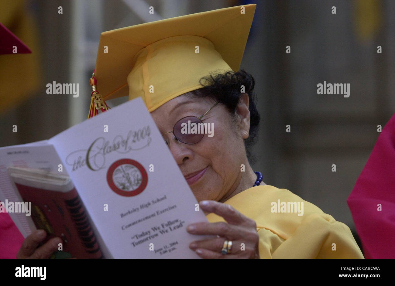 Margaret Kusaba (cq) reads the Class of 2004 graduation program before ...