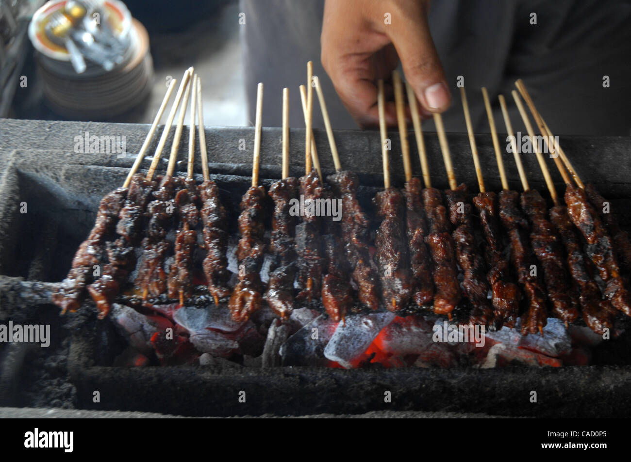 A food seller grill horse meat satay in Yogyakarta, Java Island ...