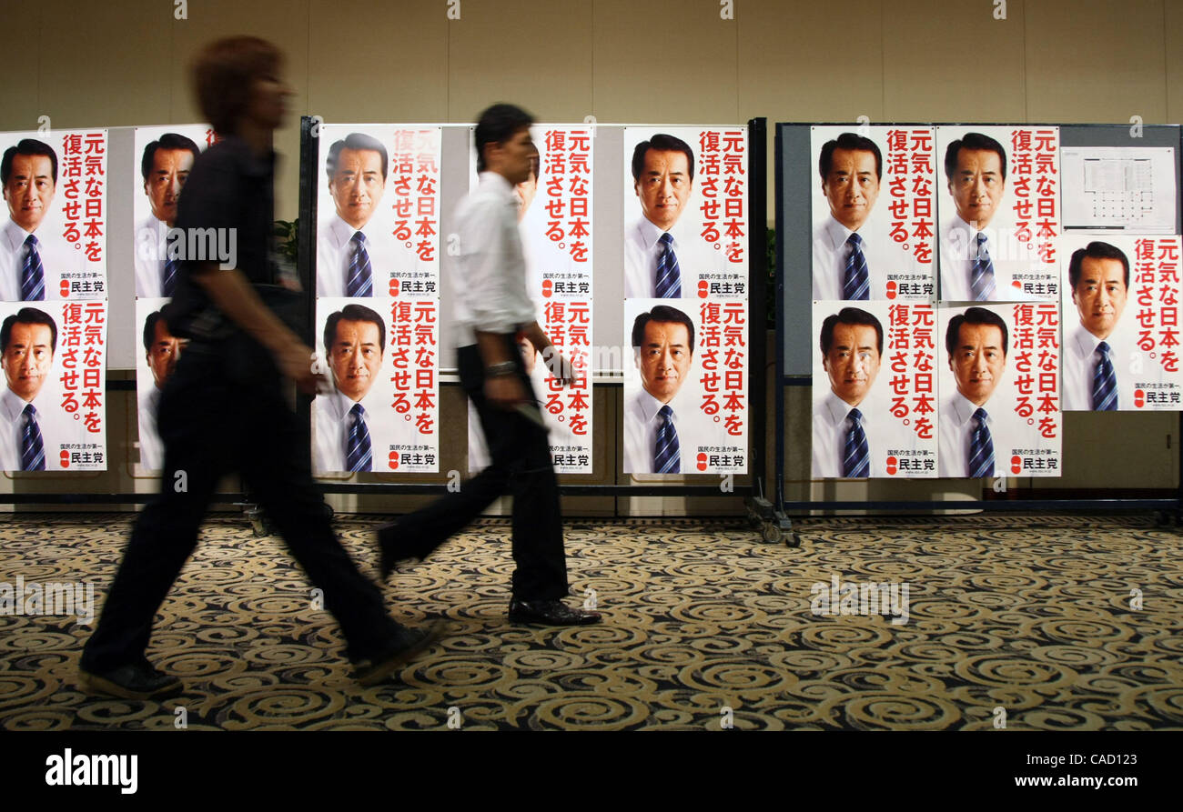 Jul 11, 2010 - Tokyo, Japan - Media reporters walk by the posters of ...