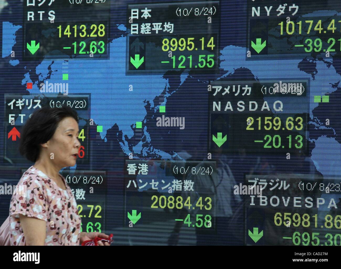 Aug 24, 2010 - Tokyo, Japan - A woman passes by an electric board ...
