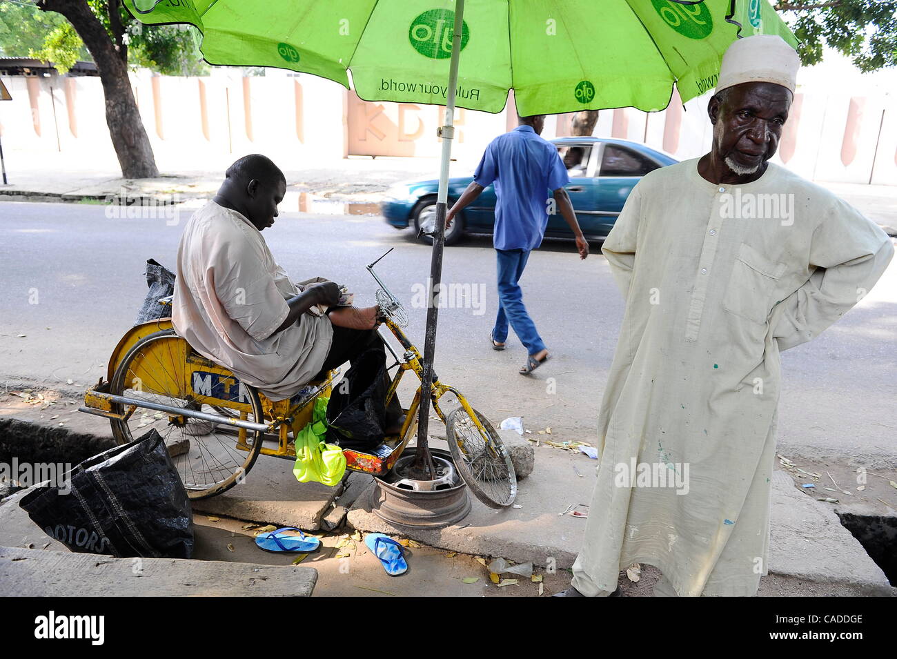 Aug. 5, 2010 - Kano, KANO, NIGERIA - Polio victim Ali Isa, left, sits ...