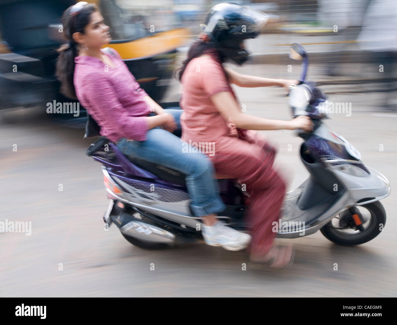 Travelers crowd onto motorcycles on the road in Bangalore, Karnataka ...