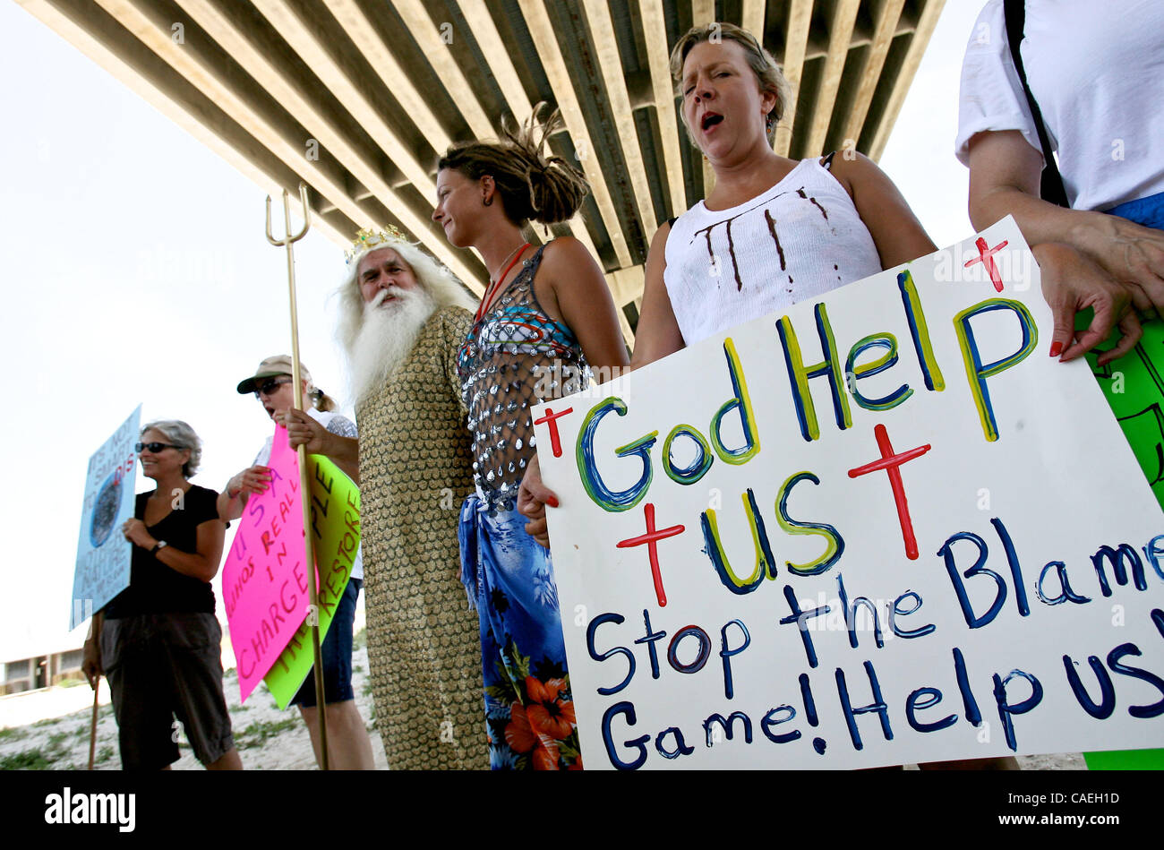 Linda Abston (right) holds a sign with other protesters under a bridge ...
