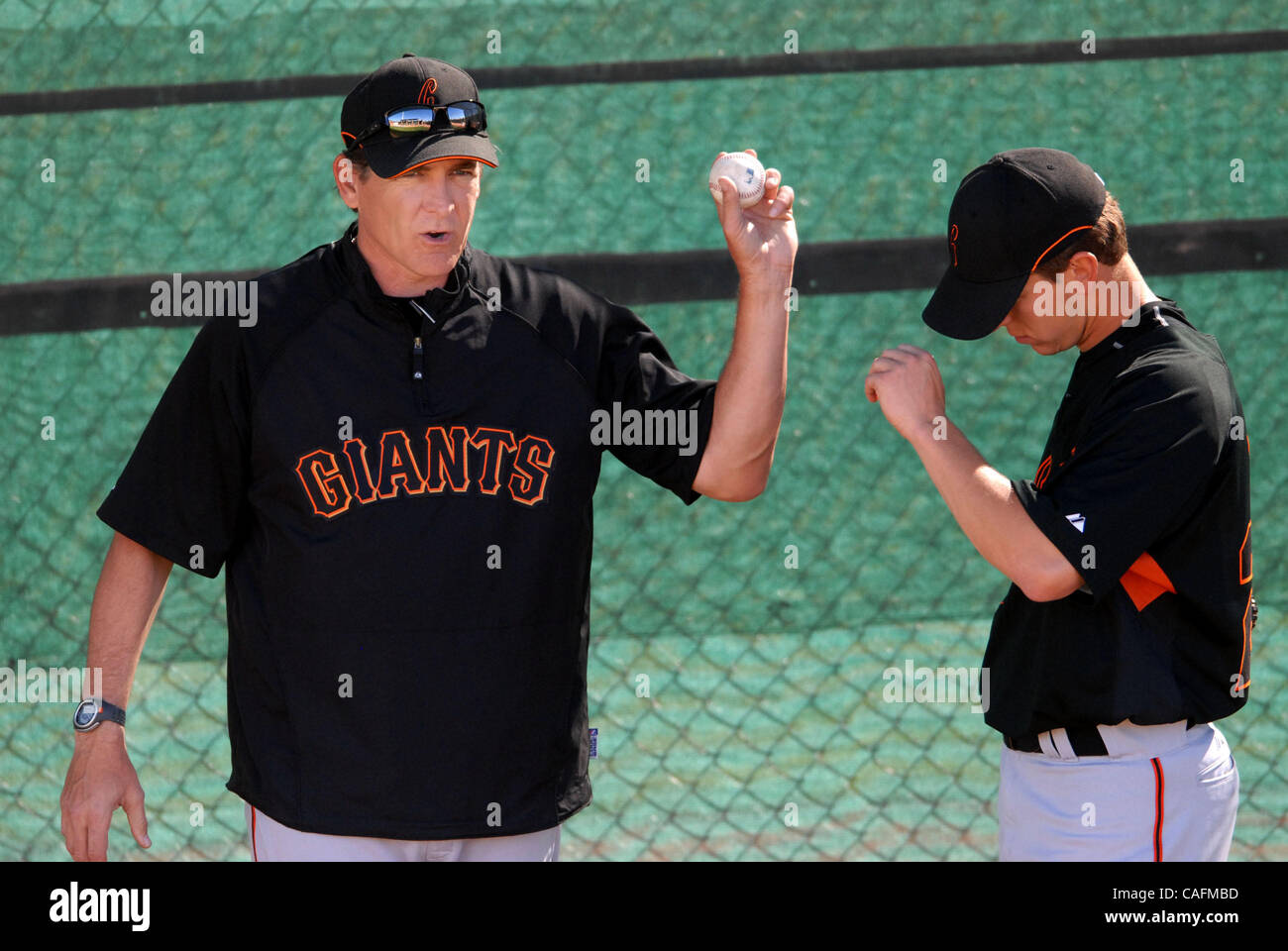 San Francisco Giants pitching coach Dave Righetti, left, works with ...